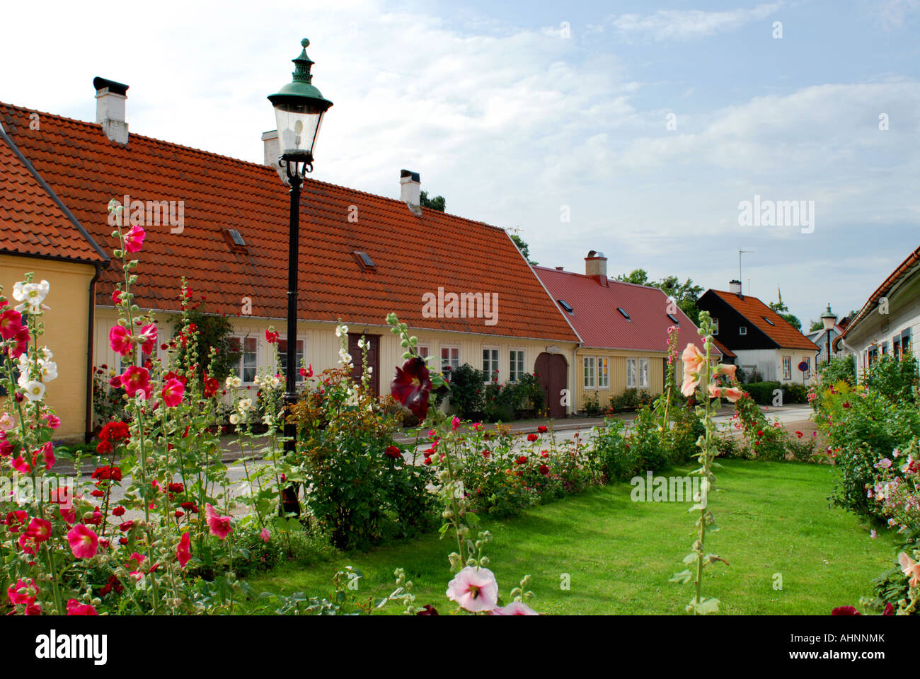 Pretty cottages in the side streets of Bastad Sweden Hollyhocks form ...