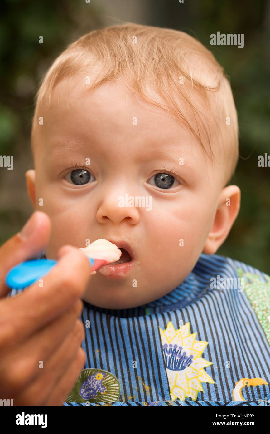 BABY BOY EATING WITH SPOON Stock Photo - Alamy