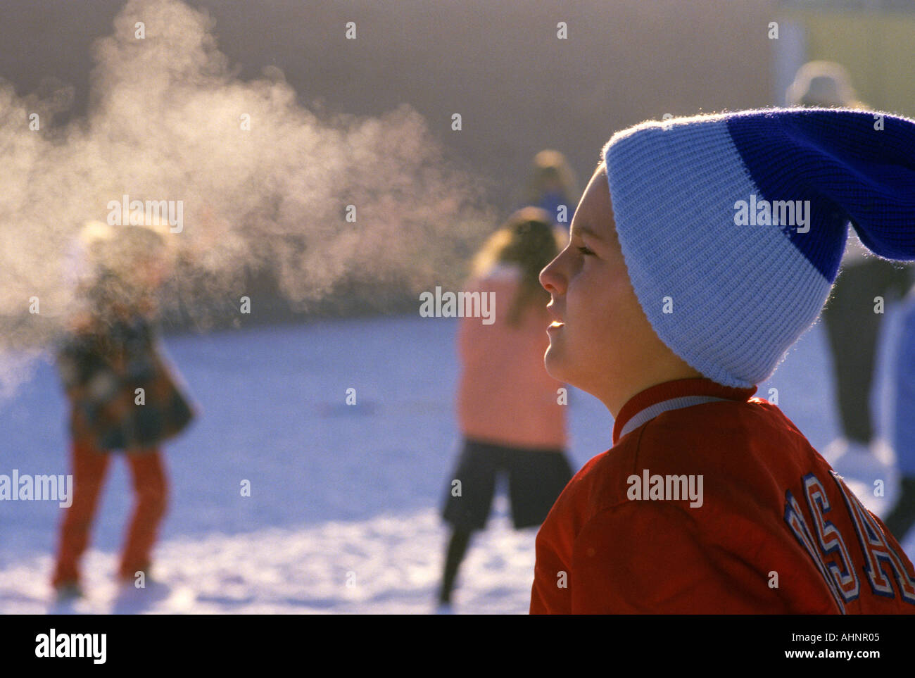 Cold weather makes a boys breath visible Stock Photo - Alamy