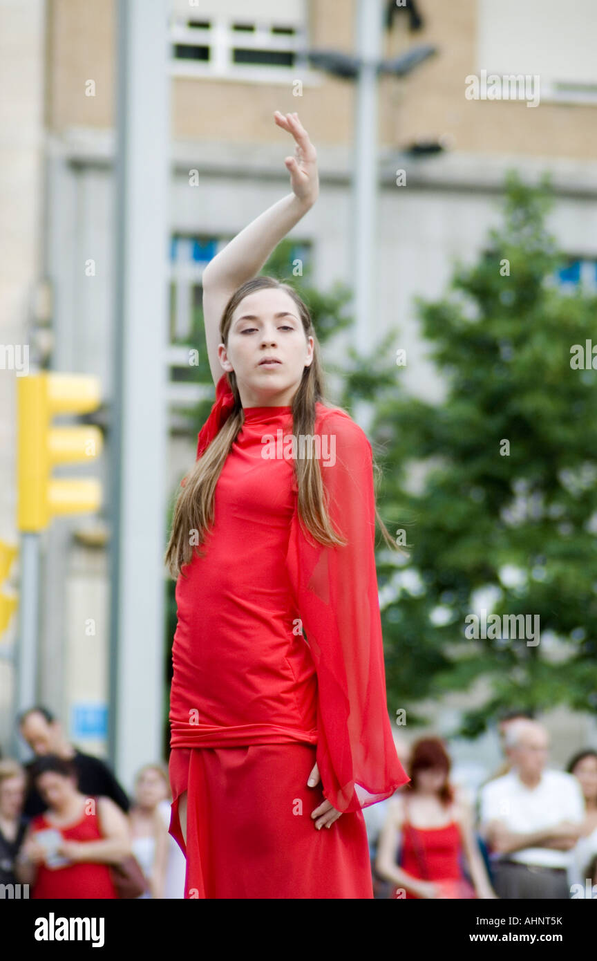 Blonde dancer with red clothing in street festival of contemporary ...