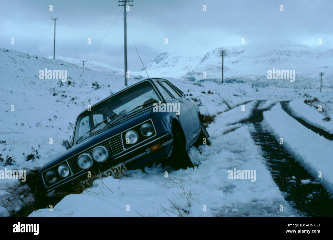 Car in a ditch in winter, near Torridon, Highland Region, Scotland, UK ...
