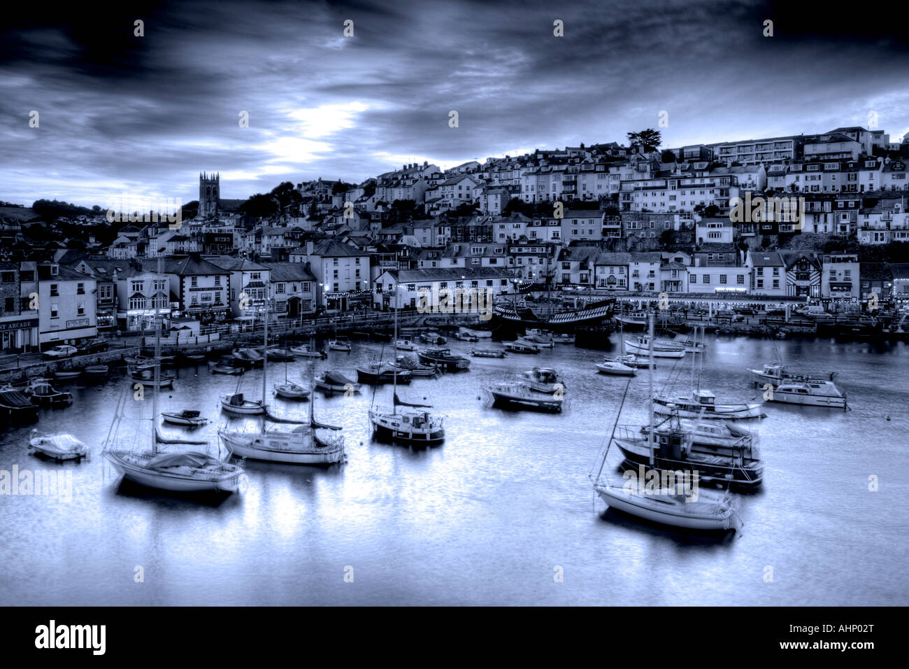 The small fishing town of Brixham on the South Devon coast at sunset ...