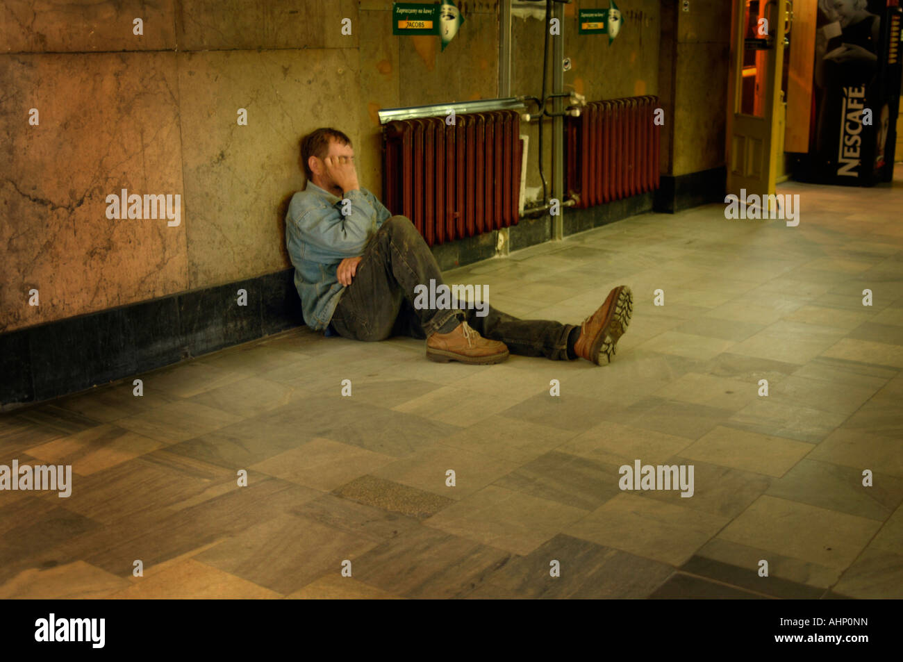 A tramp or drunk resting on the floor of Szeczin train station Stock ...