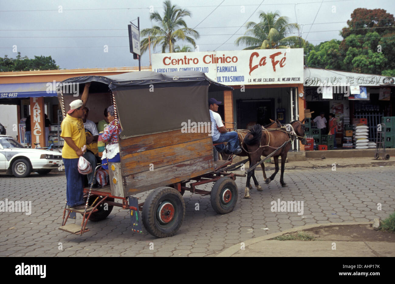People riding in a horse-drawn taxi, Masaya, Nicaragua, Central America ...