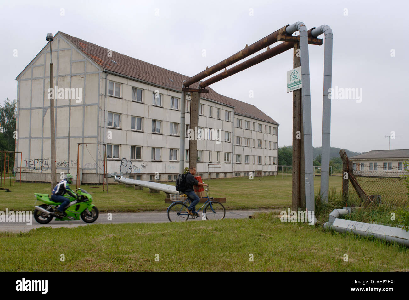 Socialist era poor housing with utility pipes crossing a road in the ...