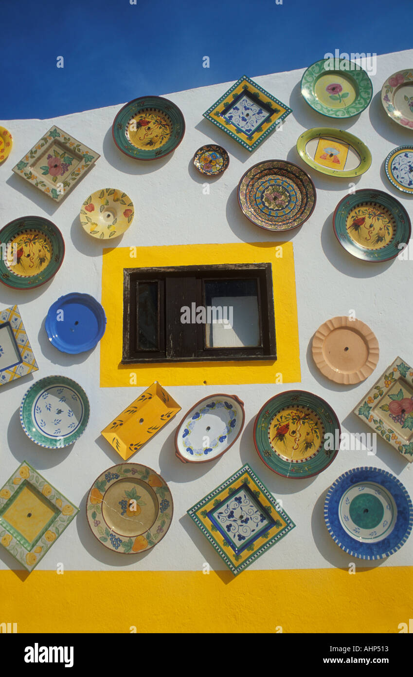 Traditional typical portuguese pottery plates on wall of pottery ...