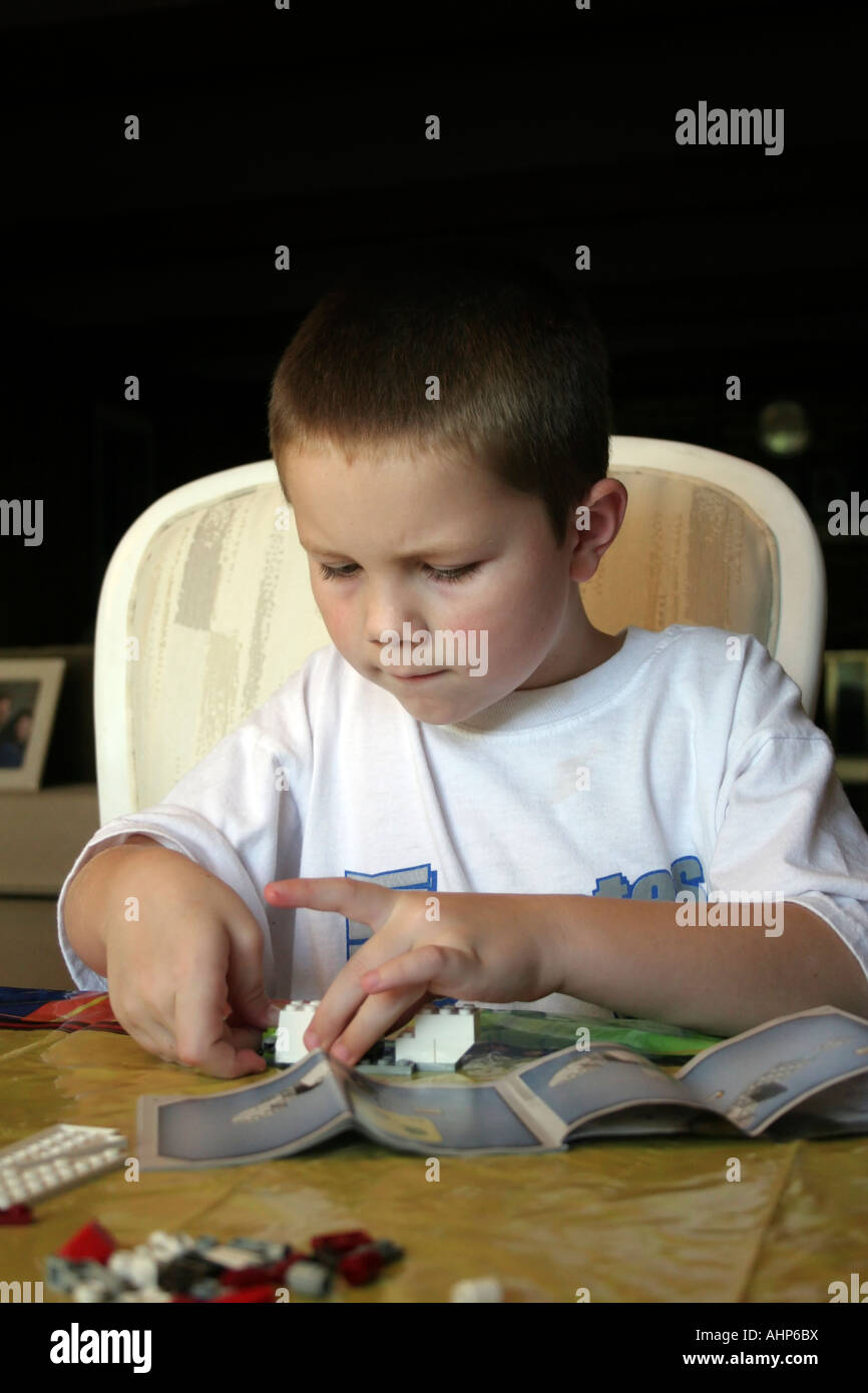 Young boy age 7 putting together Lego set Stock Photo - Alamy