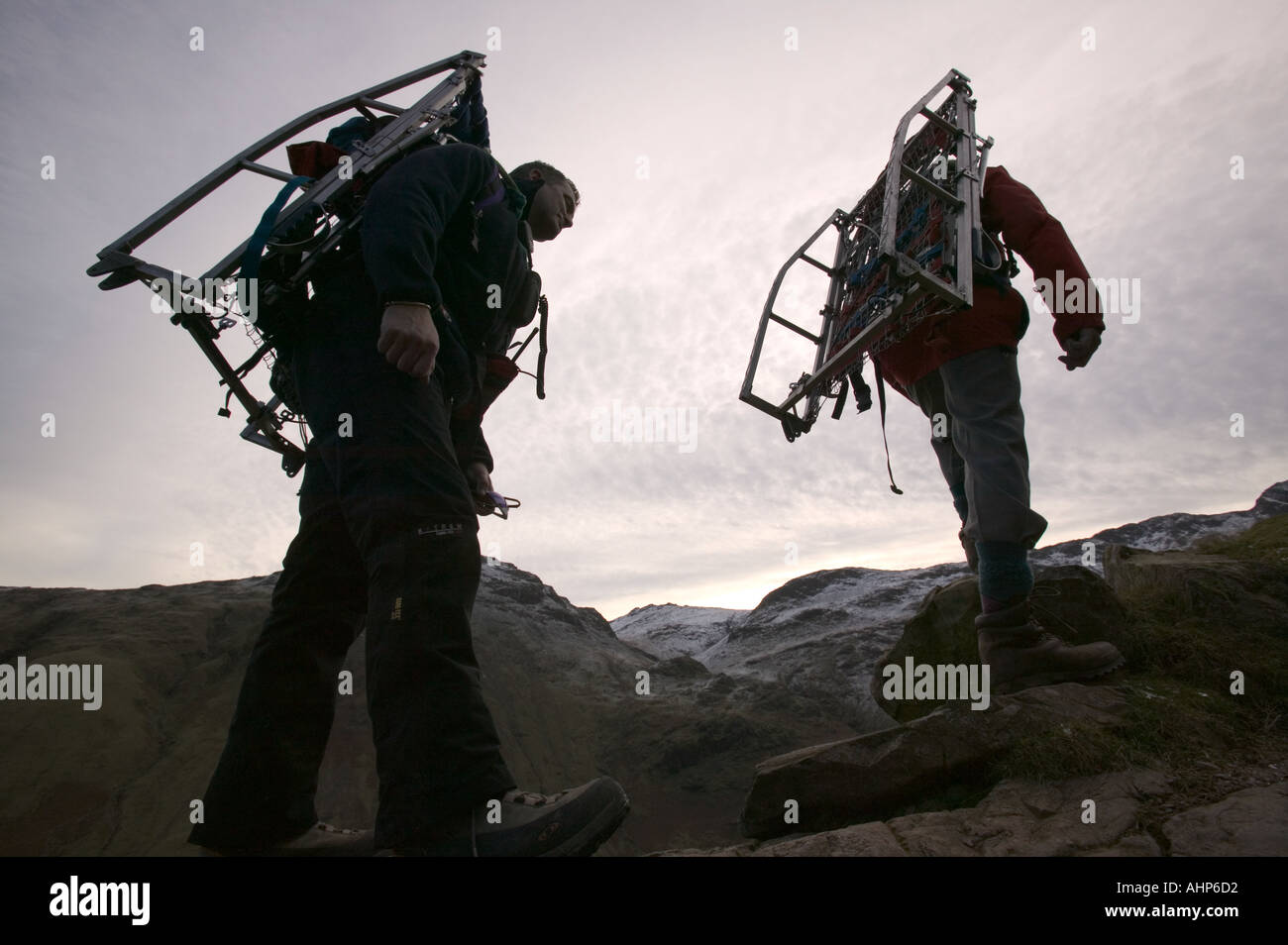 Mountain Rescue volunteers carry a stretcher up Bow Fell Stock Photo ...