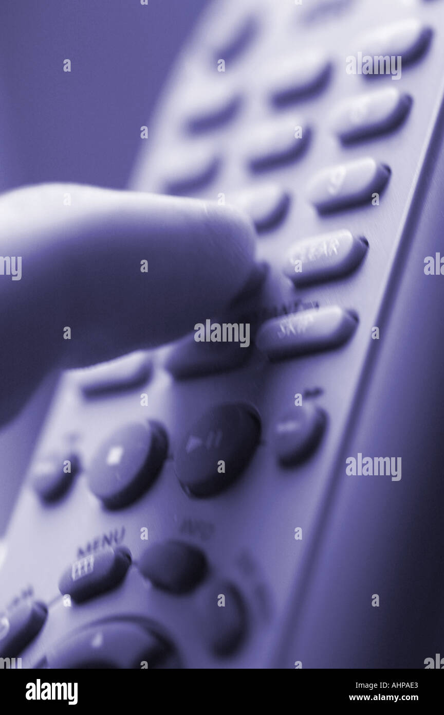 finger pushing buttons on a remote control Stock Photo - Alamy