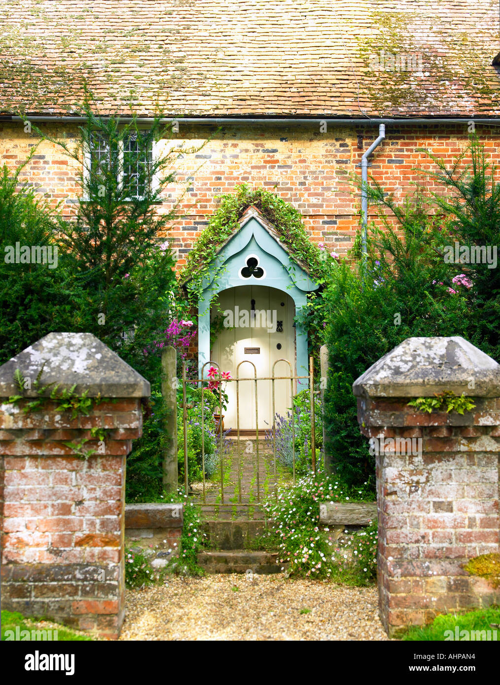 Country cottage with a path leading to a porch and door Stock Photo - Alamy