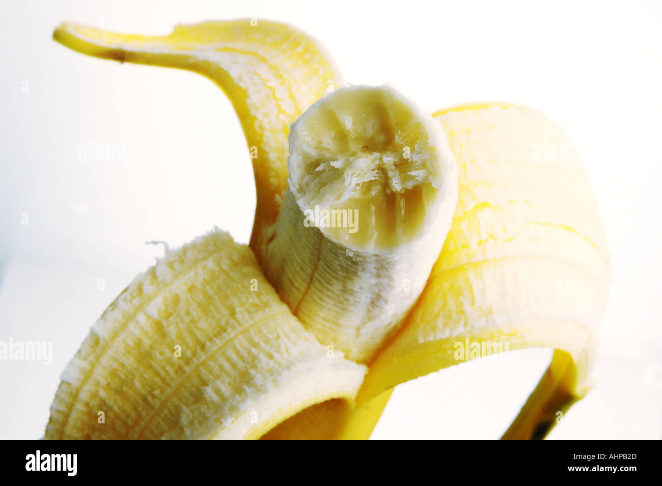 Banana with bite taken out fruit on a white background Stock Photo - Alamy