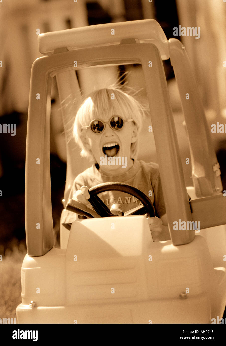 Crazy boy driving toy car Stock Photo - Alamy