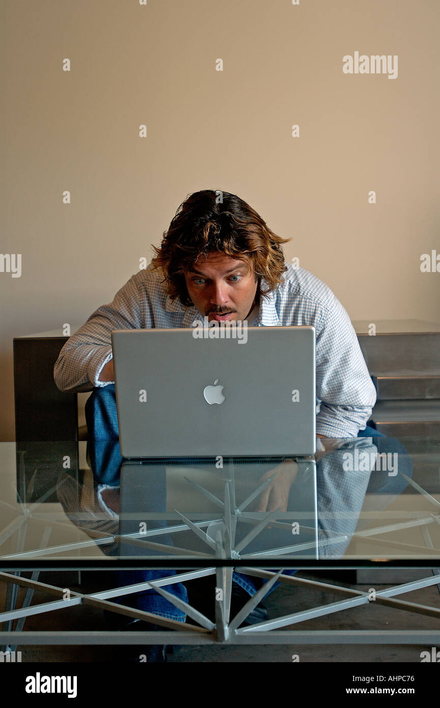 man sitting in front of laptop computer Stock Photo - Alamy