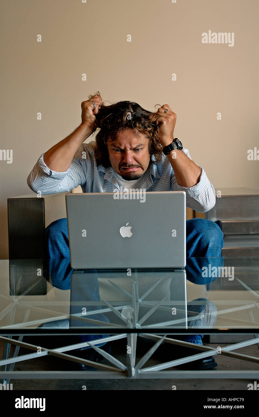 man sitting in front of laptop computer Stock Photo - Alamy