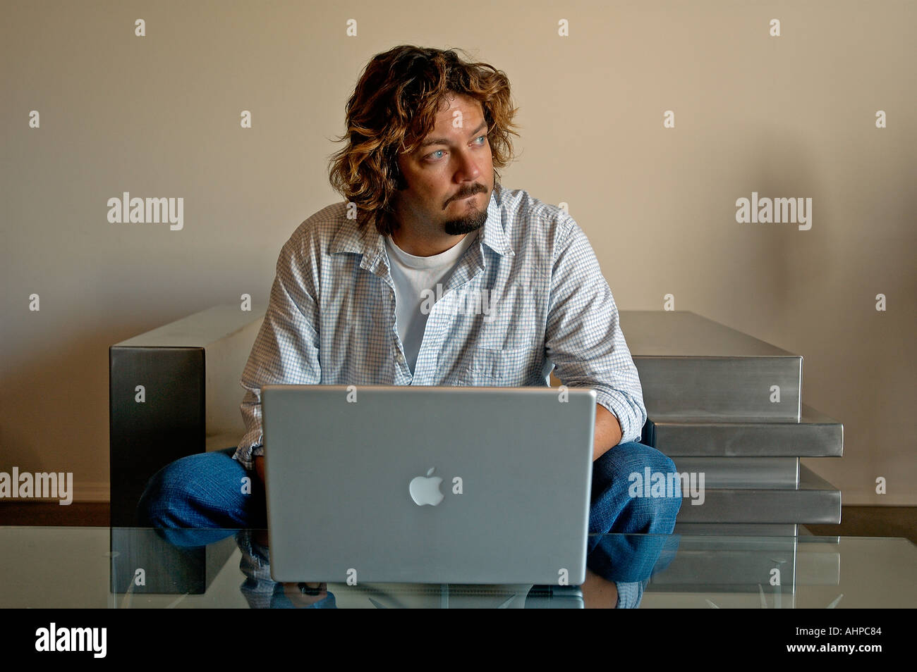 man sitting in front of laptop computer Stock Photo - Alamy