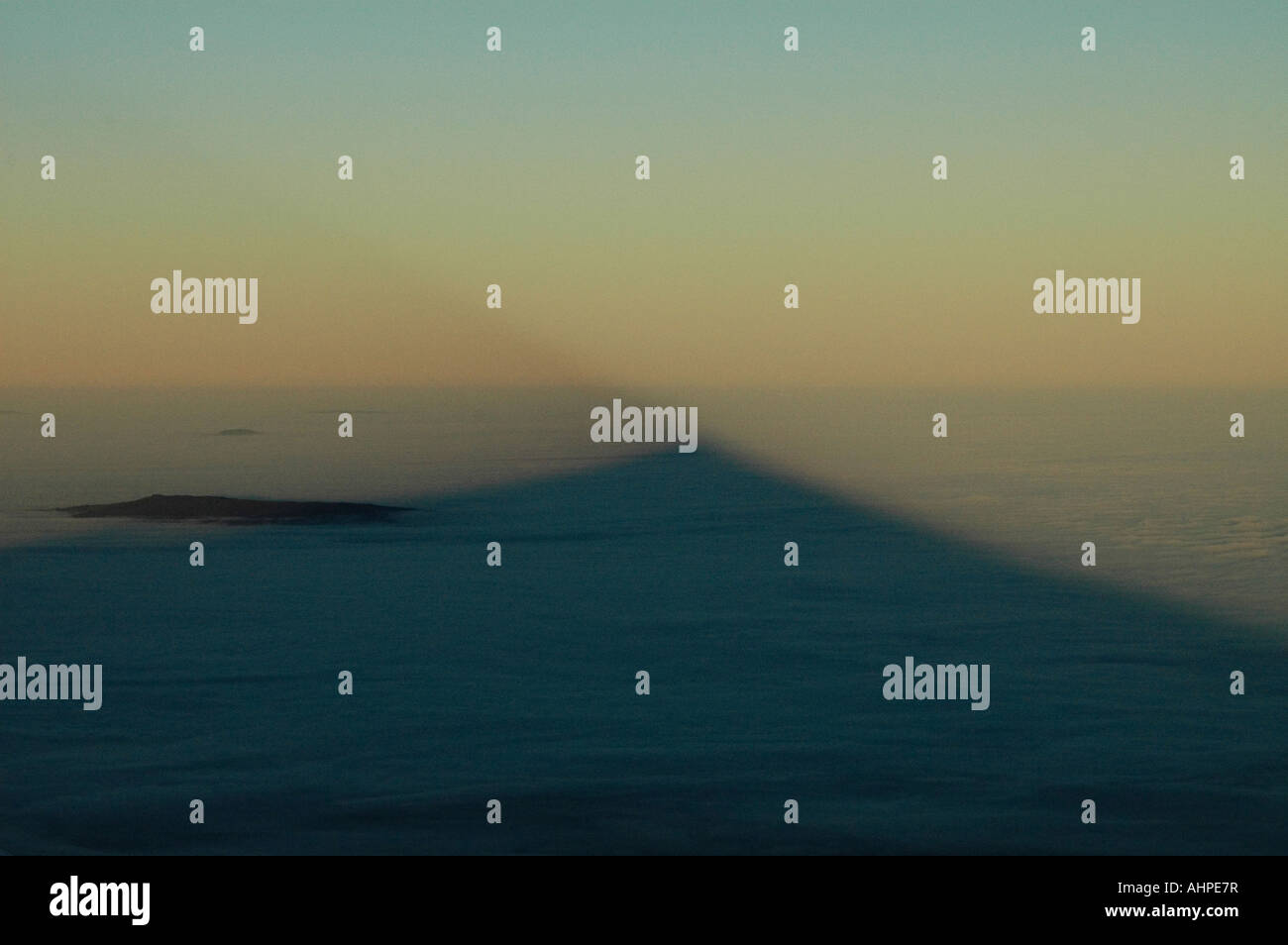 Shadow of Volcano Villarrica on the clouds at dawn PucÃ n Patagonia ...