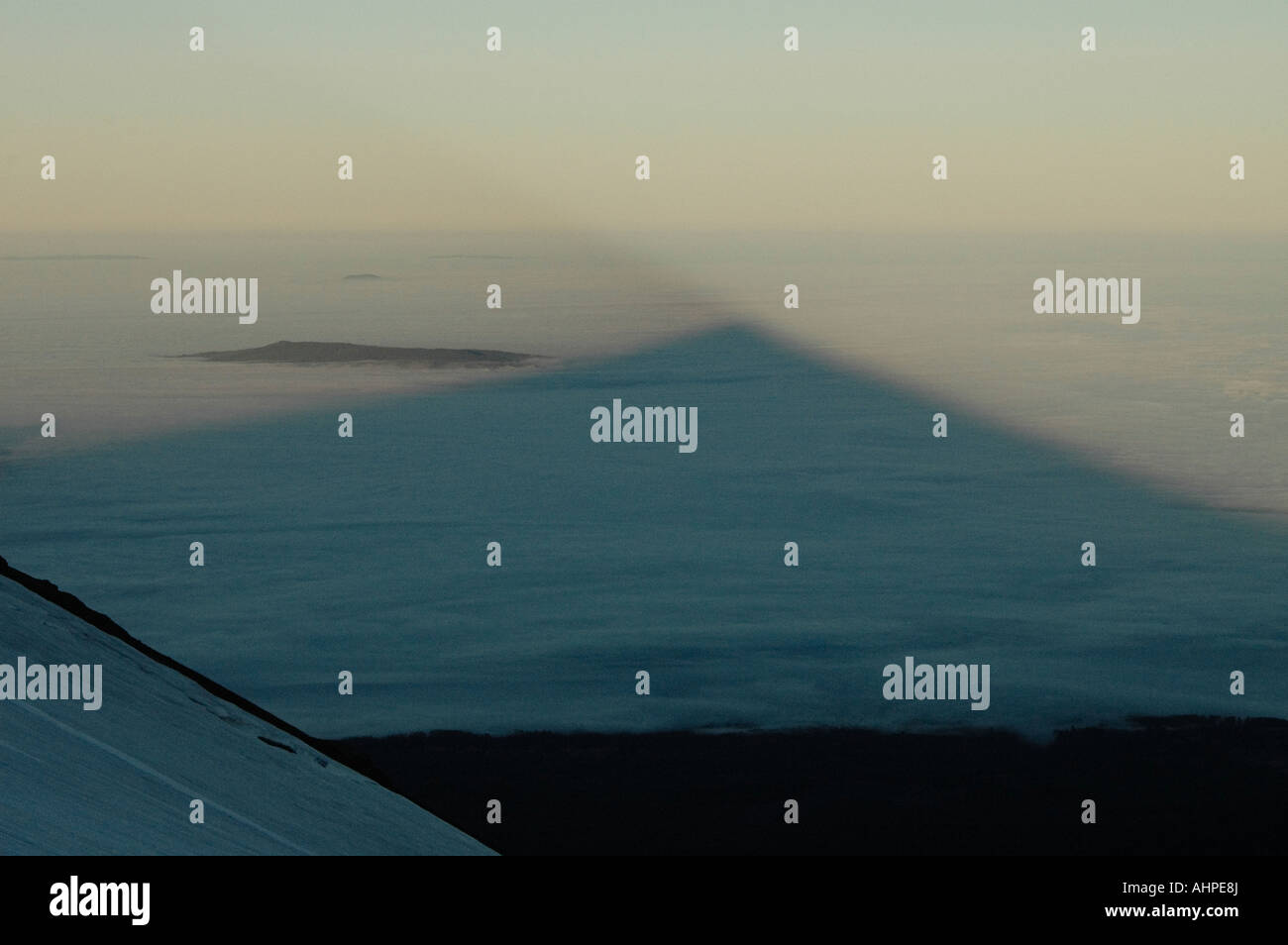 Shadow of Volcano Villarrica on the clouds at dawn PucÃ n Patagonia ...