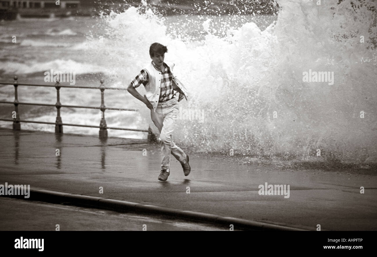 Man running from wave hi-res stock photography and images - Alamy