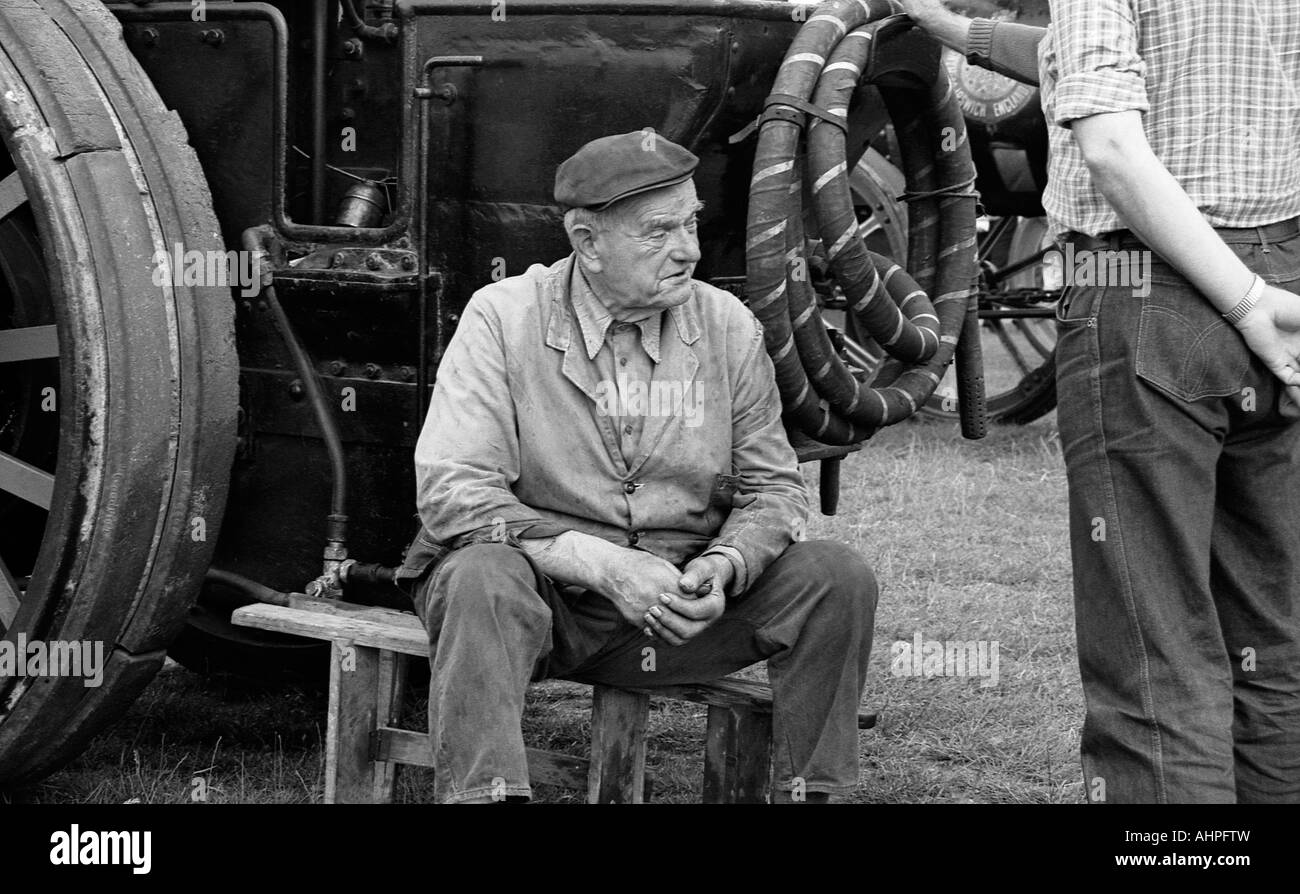 Old man traction engine owner sitting on wooden bench resting Stock ...