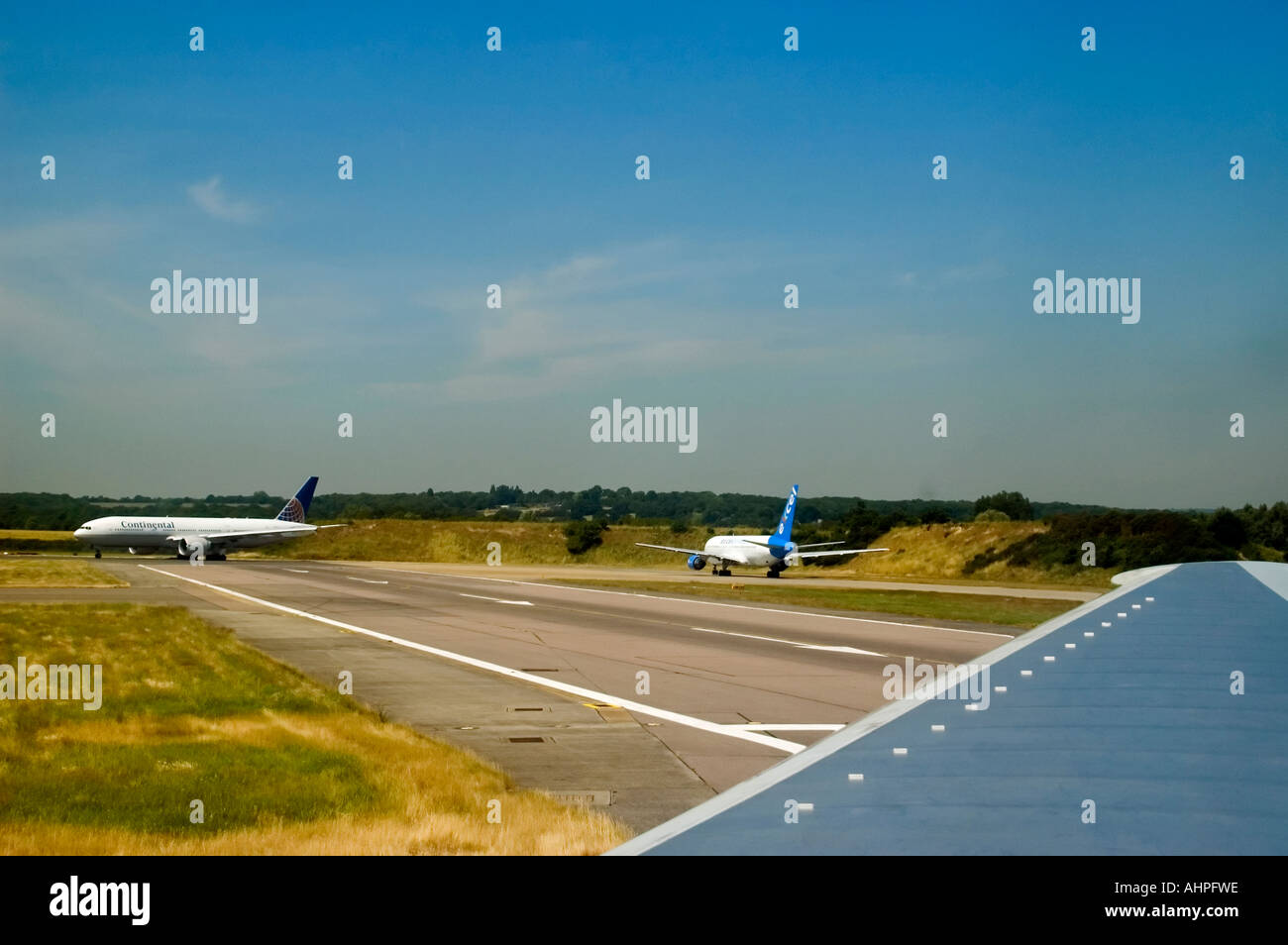 Horizontal wide angle of several large commercial aircraft in a queue ...