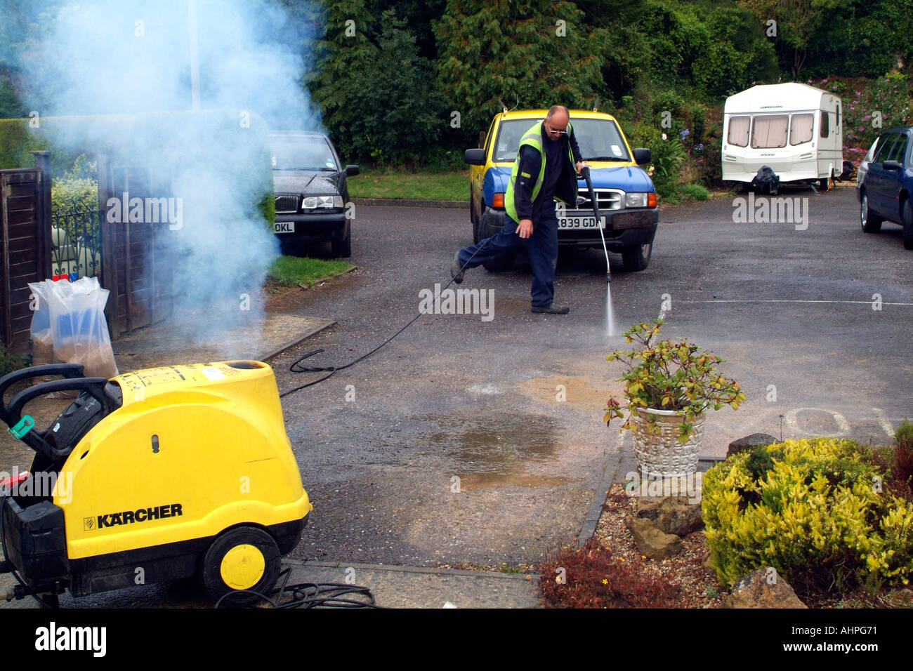 Pollution clean up using a high powered hose Stock Photo - Alamy