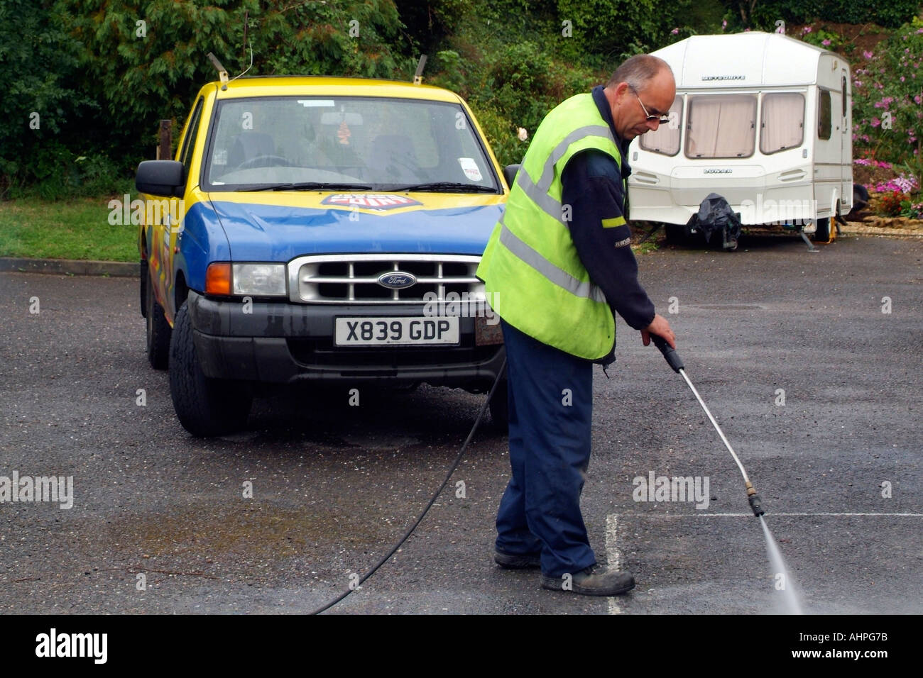 Pollution clean up using a high powered hose Stock Photo - Alamy