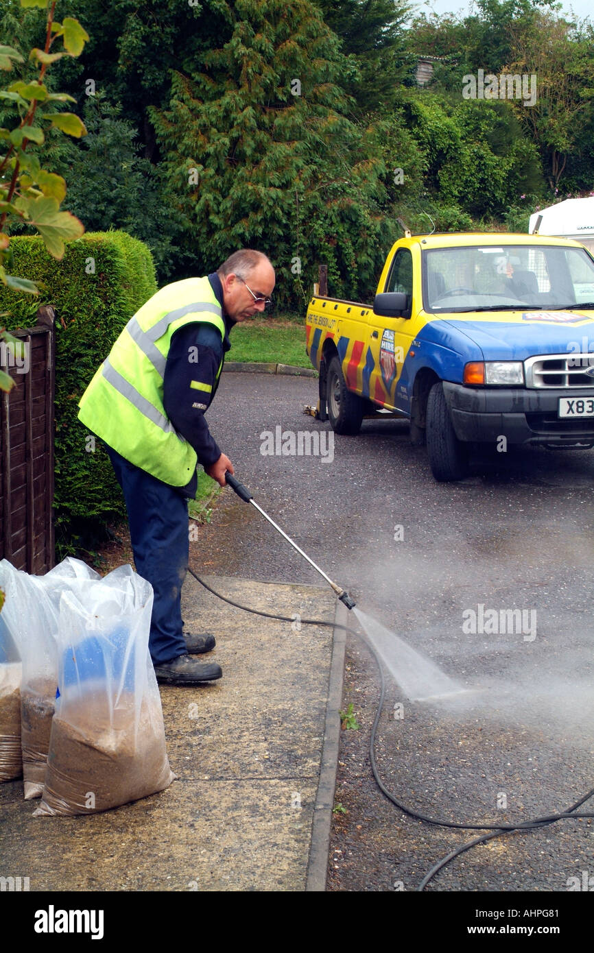 Pollution clean up using a high powered hose Stock Photo - Alamy