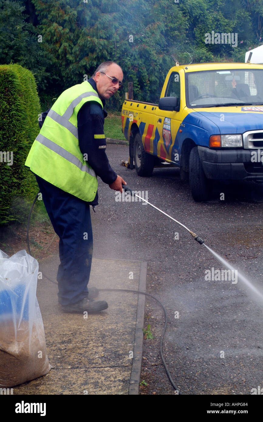 Pollution clean up using a high powered hose Stock Photo - Alamy