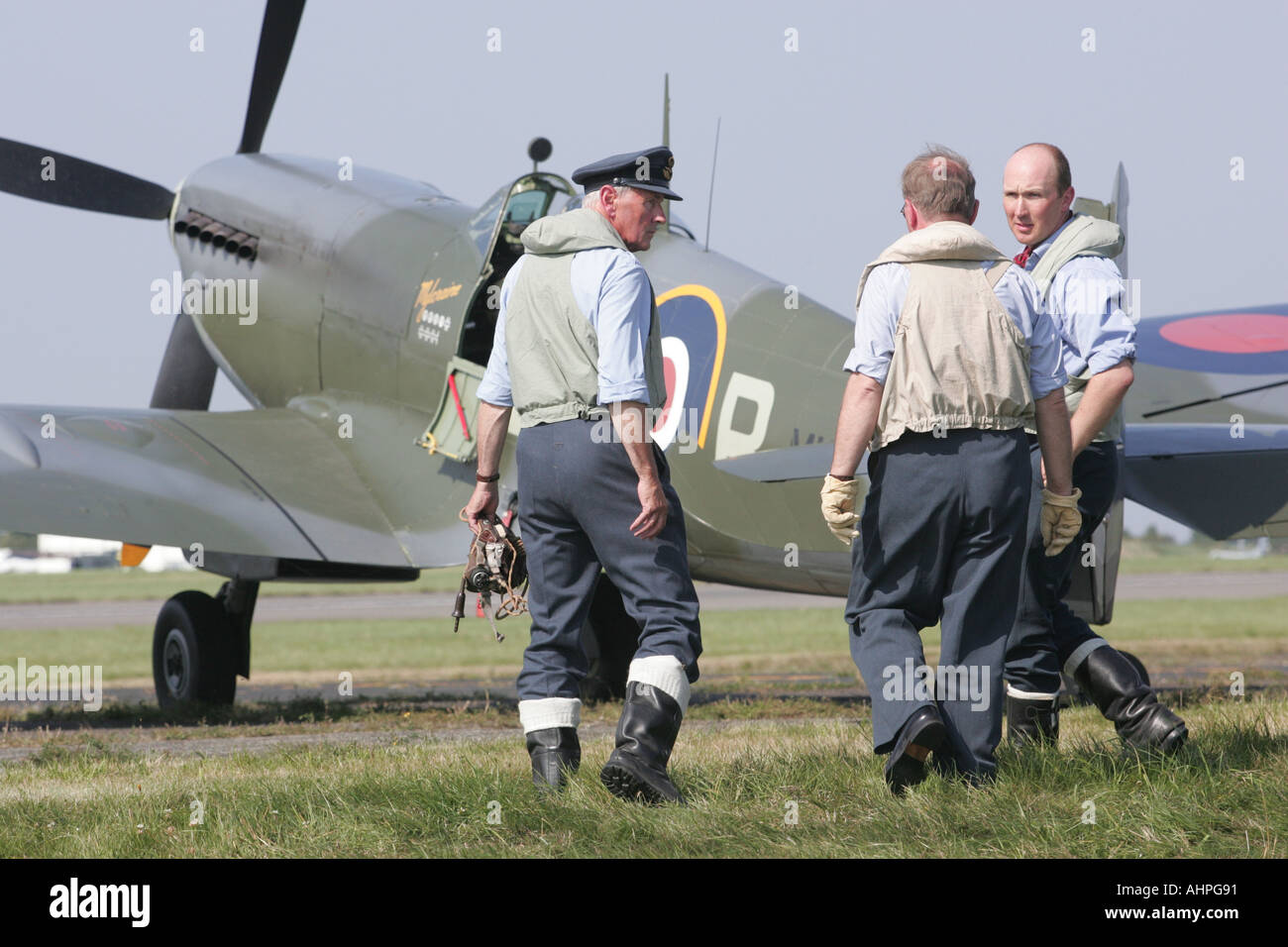 RAF at War pilots in period costume runs to a Spitfire during a WW2 ...
