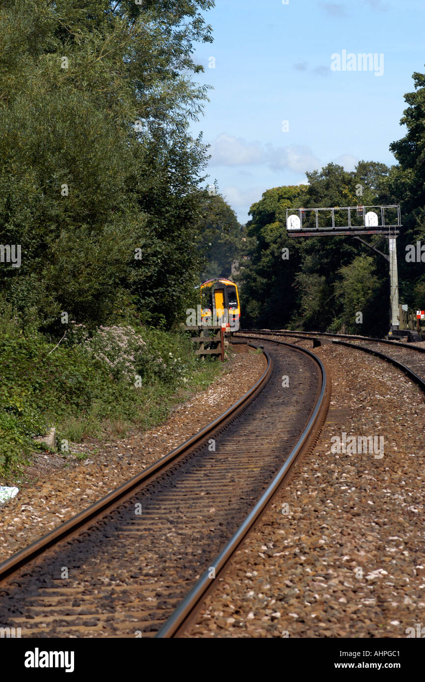 Railroad track with a British dielel train coming Stock Photo - Alamy