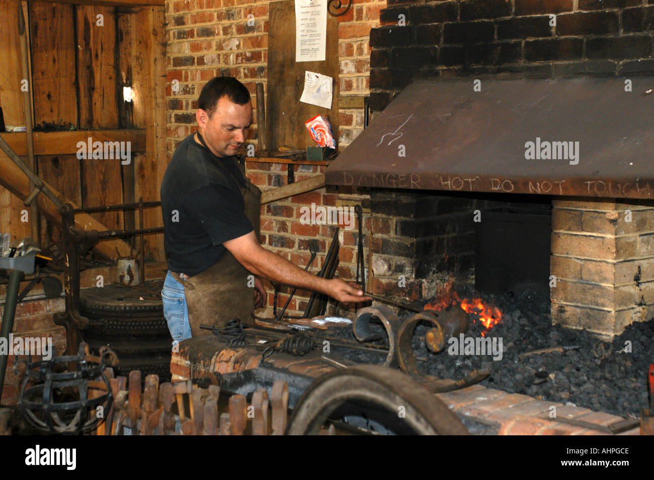 A Blacksmith at work in his forge creating a set of Wrought Iron gates ...