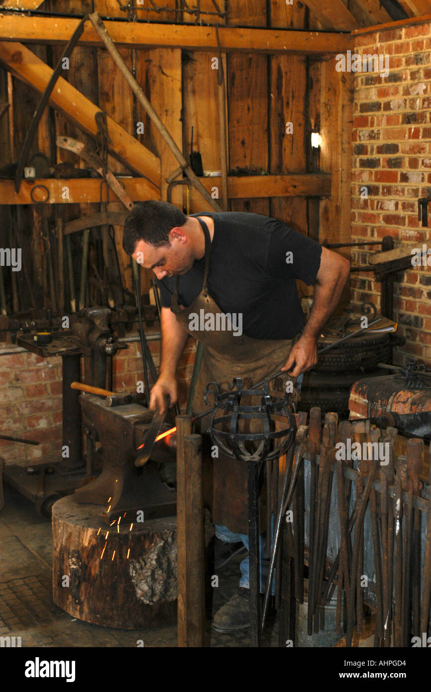 A Blacksmith at work in his forge creating a set of Wrought Iron gates ...