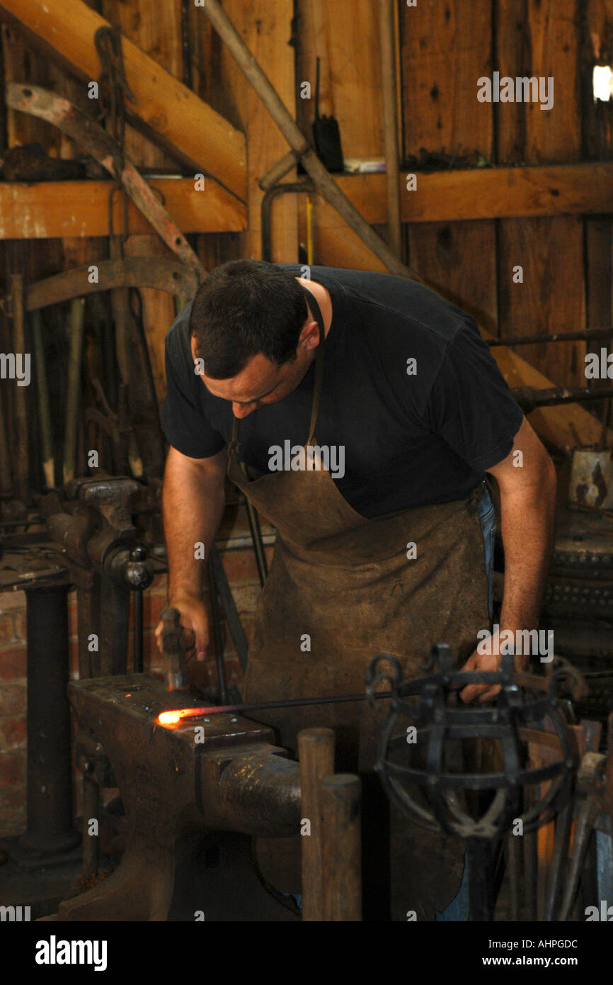 A Blacksmith at work in his forge creating a set of Wrought Iron gates ...