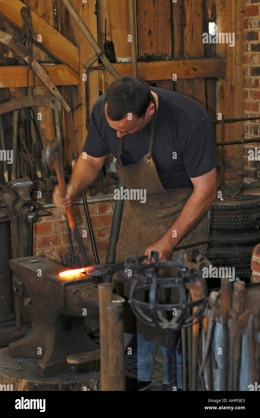 A Blacksmith at work in his forge creating a set of Wrought Iron gates ...