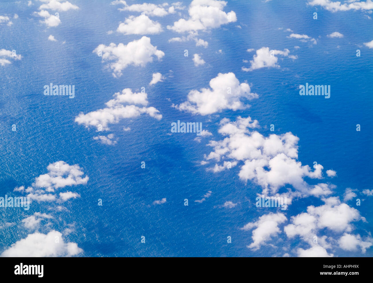 Clouds over blue sea viewed from airplane Stock Photo - Alamy