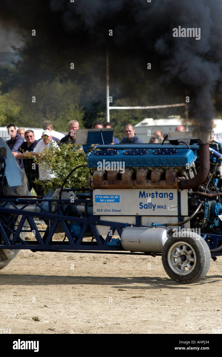 A Tractor pulling event with lots of black smoke polluting the ...