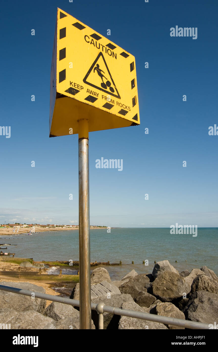 danger sign on the coast warning of dangerous rocks Stock Photo - Alamy