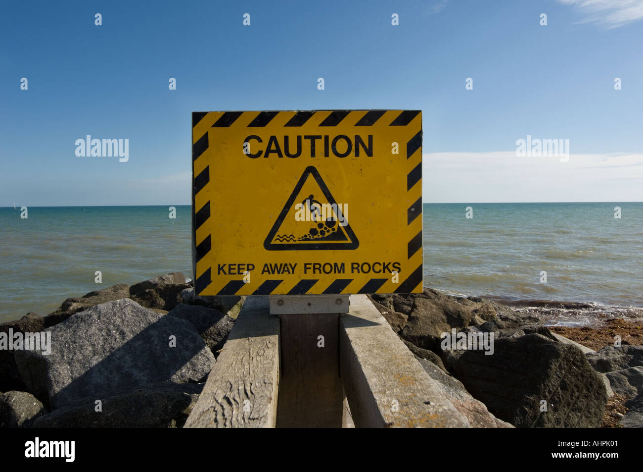 danger sign on the coast warning of dangerous rocks Stock Photo - Alamy