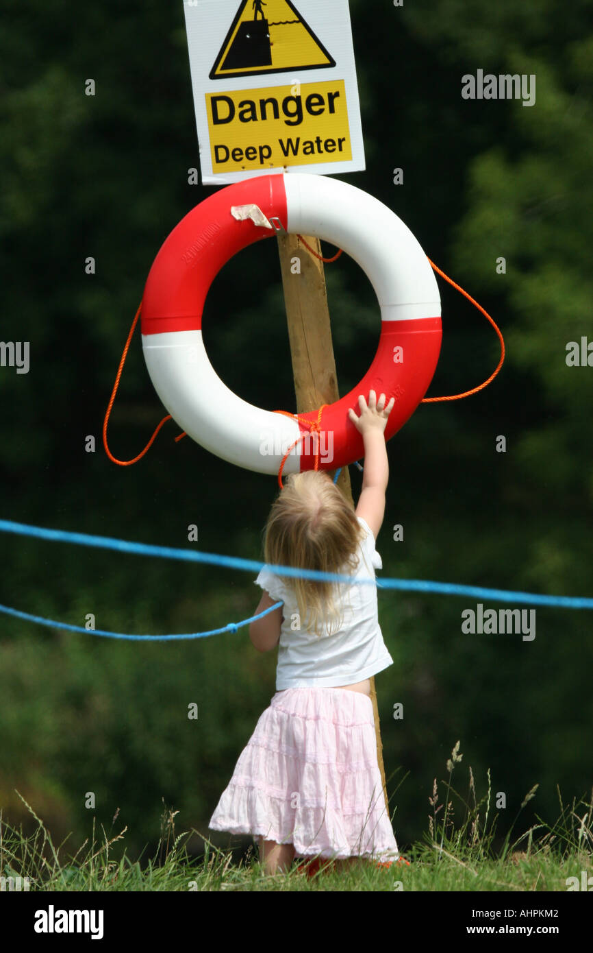 "Young child reaching for a life belt next to a River Stock Photo - Alamy