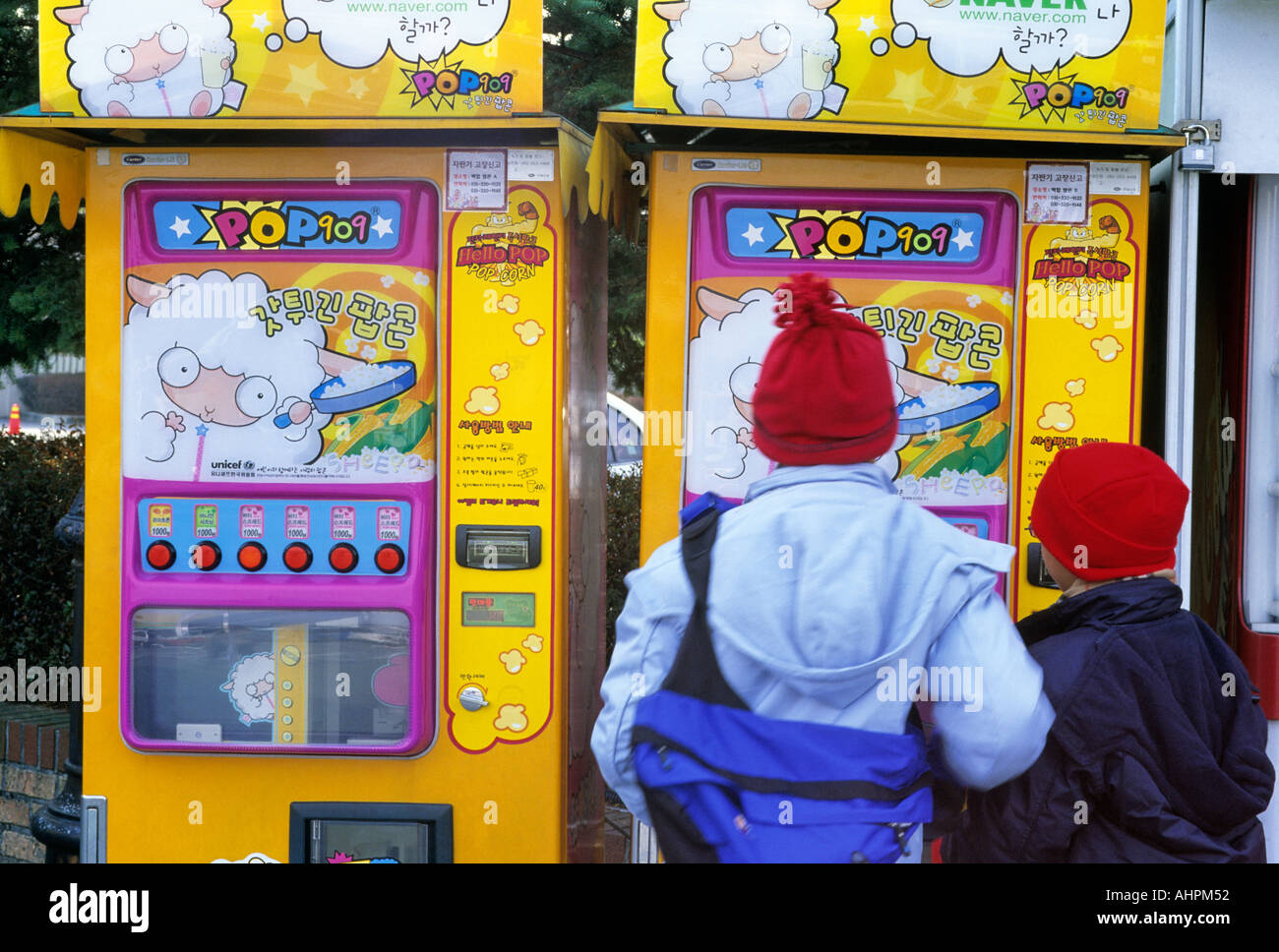 two young children operating a vending machine in Seoul city South ...