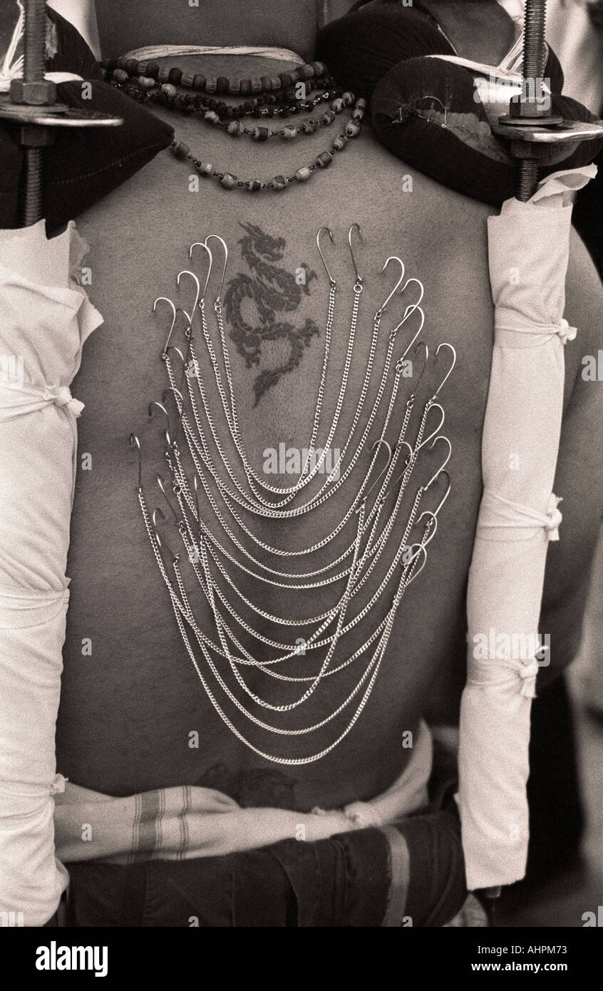 The back of a devotee showing dragon symbol and hooks during Thaipusam ...
