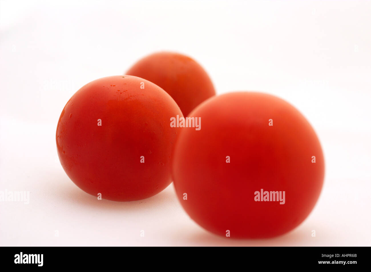 Still life of three cherry tomatoes Stock Photo - Alamy