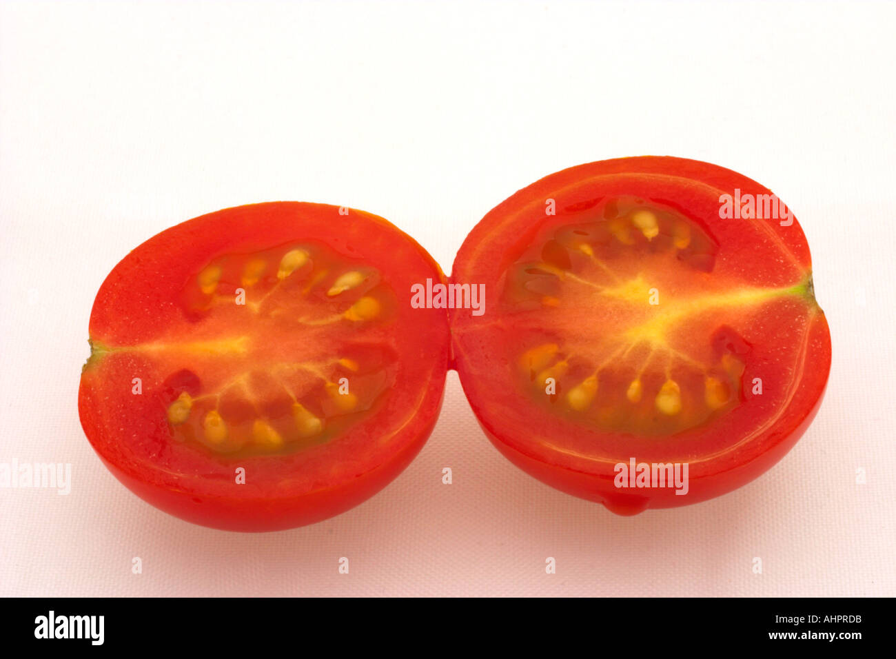 Still life of a cherry tomato cut in half Stock Photo - Alamy