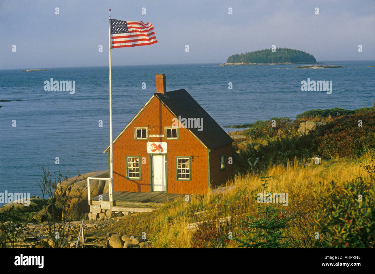 Red lobster shack overlooking the ocean with American flag flying in ...