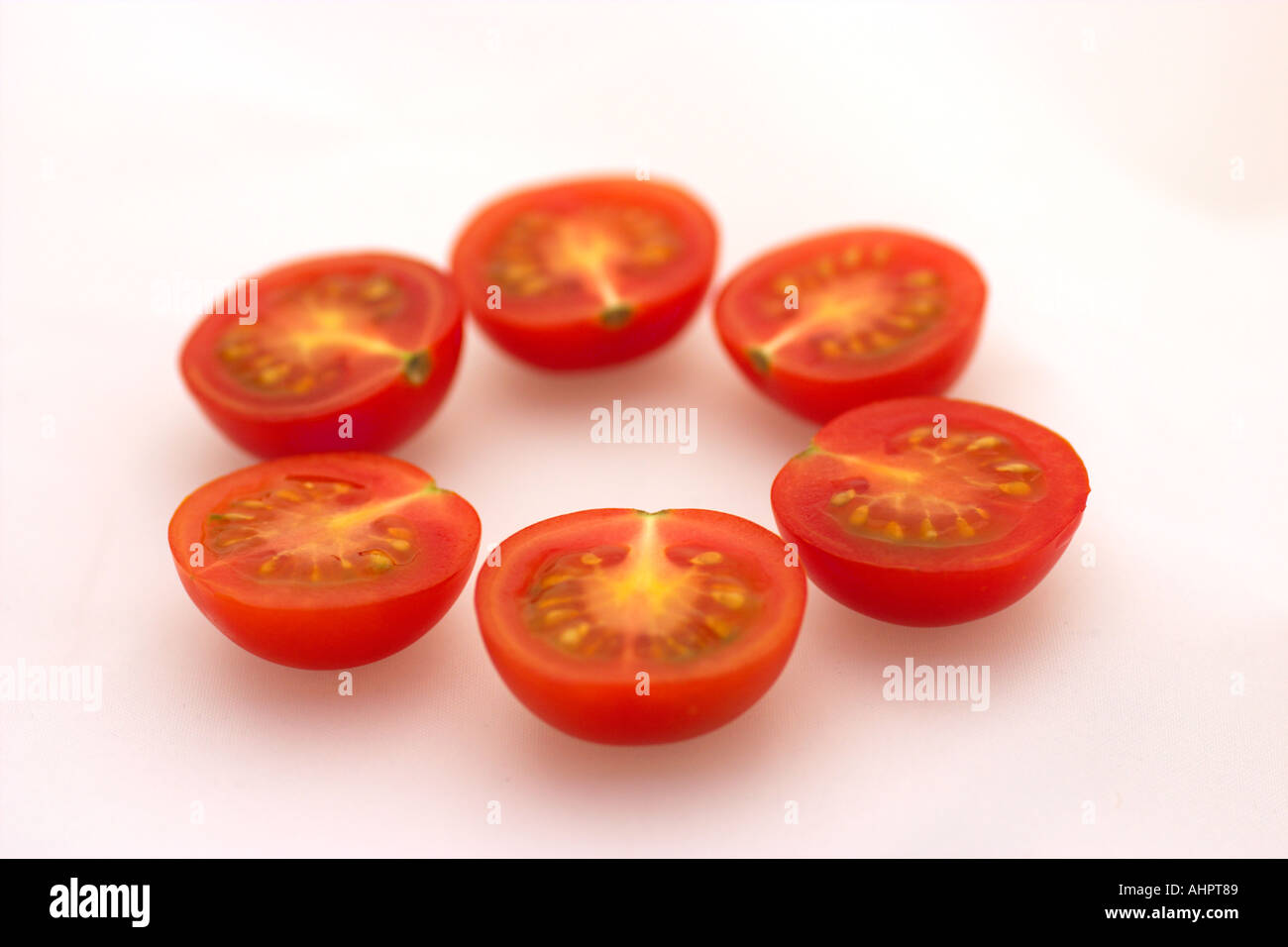 Still life of six cherry tomatoes cut in half in a circle Stock Photo ...