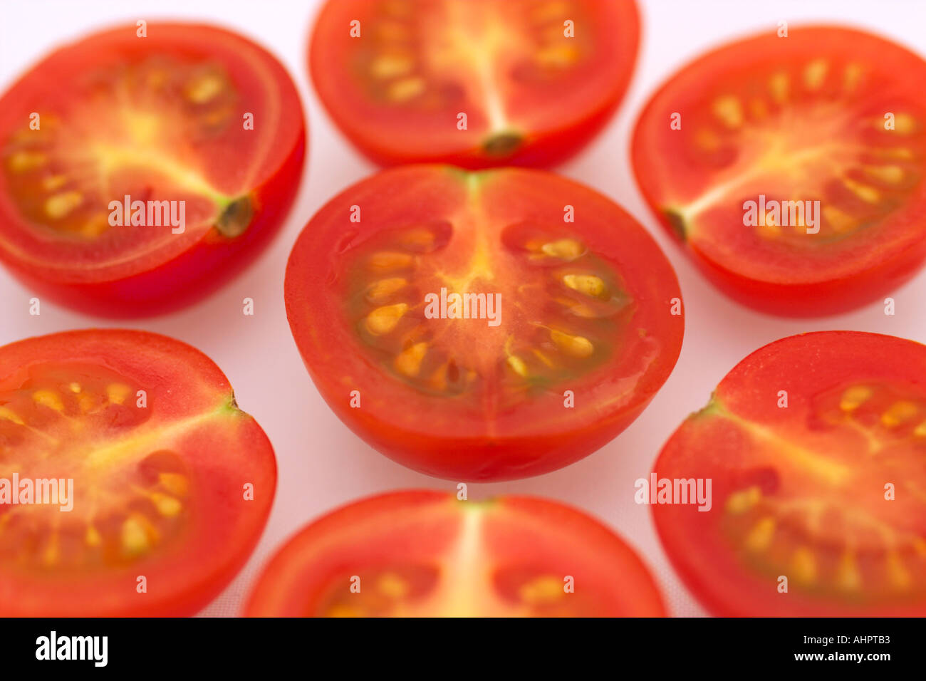Still life of cherry tomatoes cut in half in a circle Stock Photo - Alamy