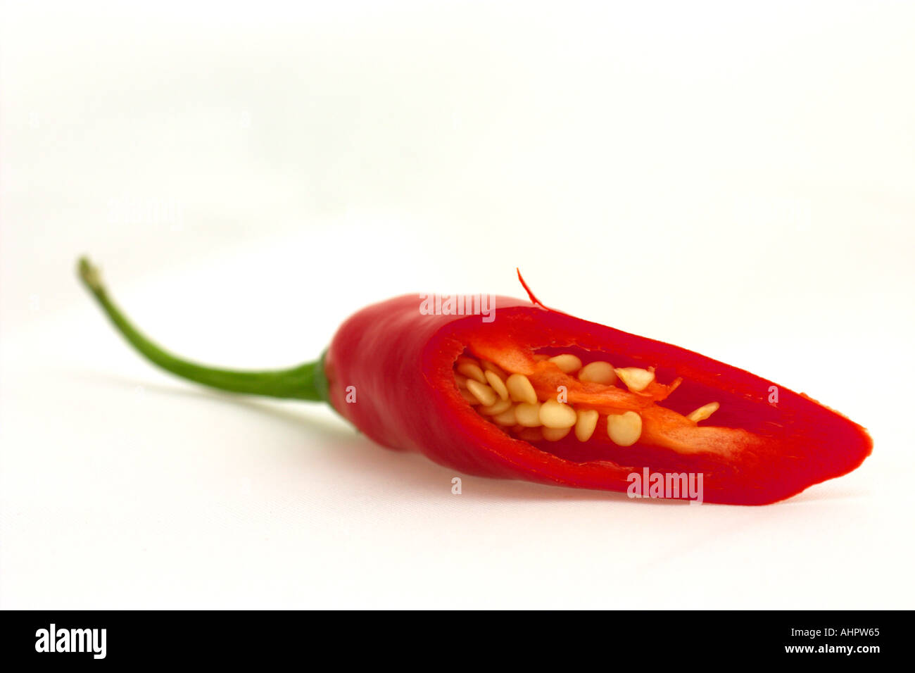 Still life of a cut red chilli Stock Photo - Alamy