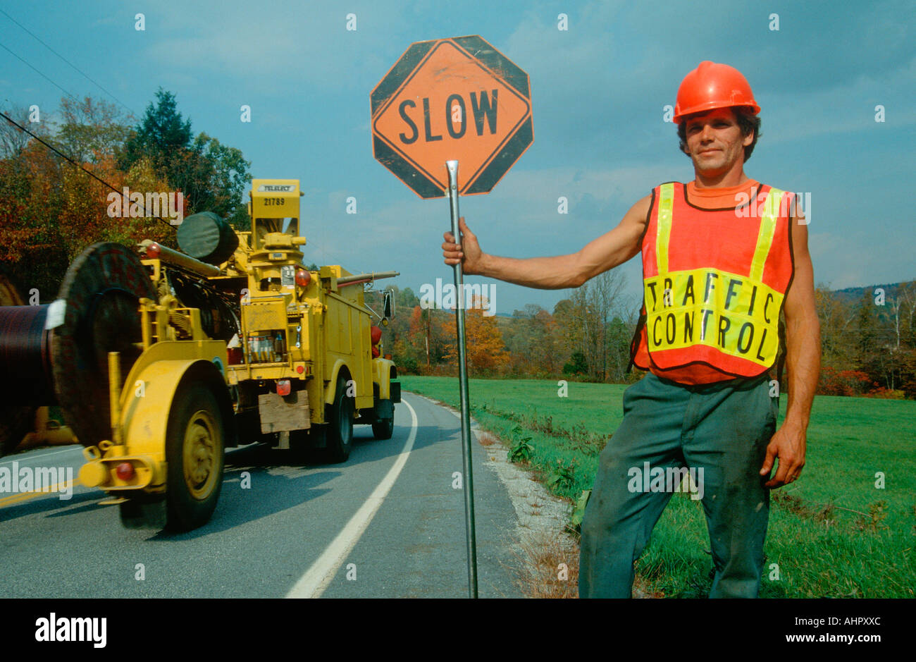 Road crewman holding traffic control sign Stock Photo - Alamy