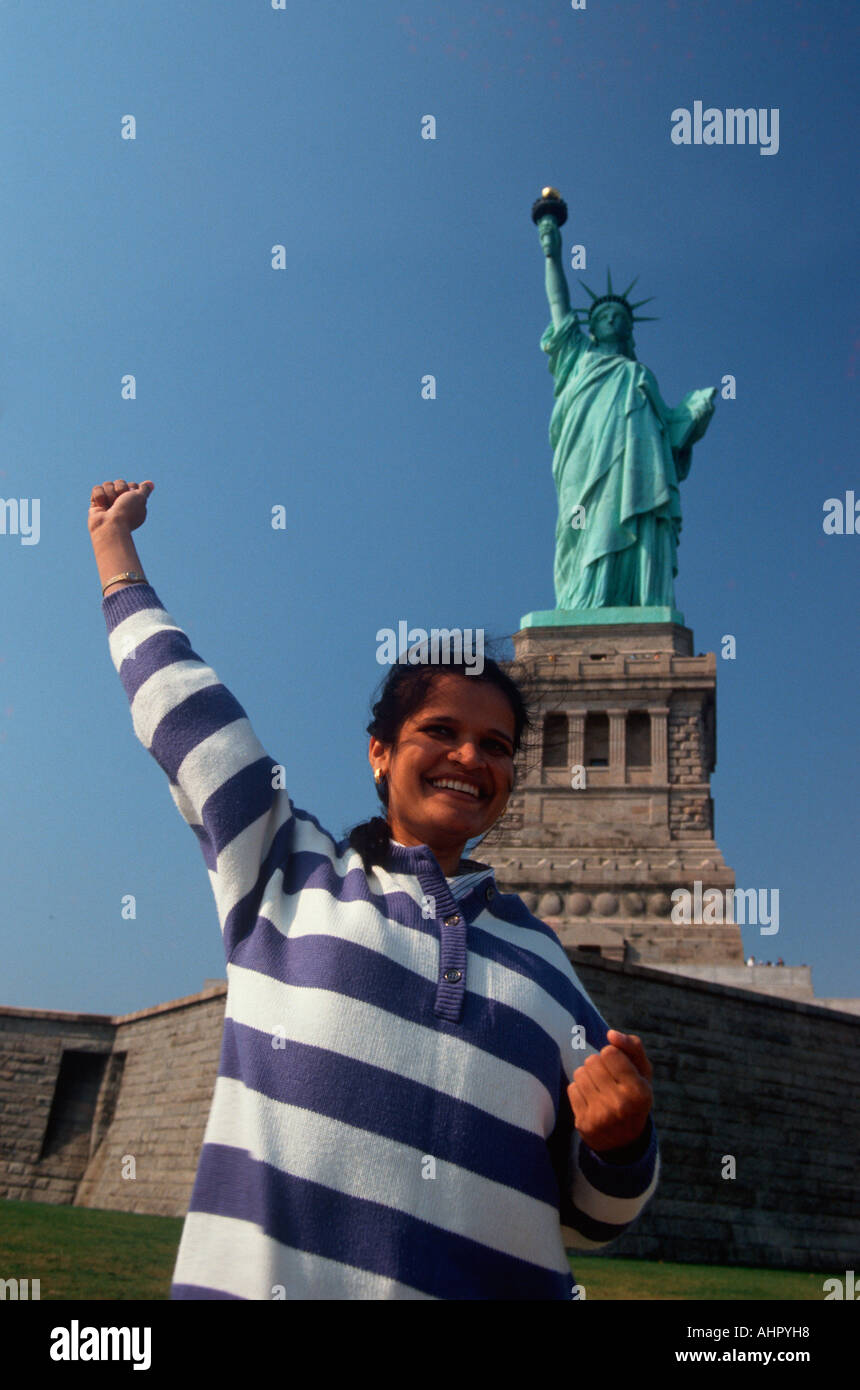 Indian American woman raising arm Statue of Liberty New York Stock ...