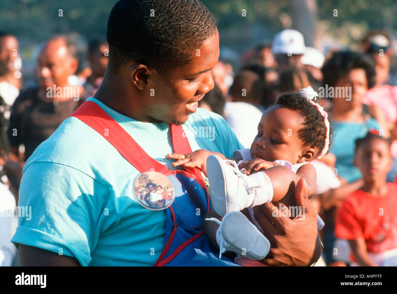 African American father holding his baby at Black Fatherhood event Los ...